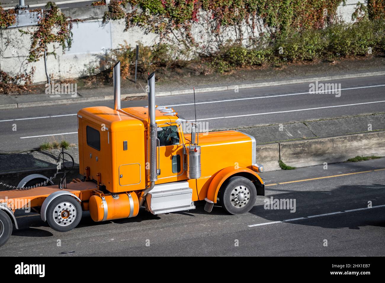 Orange industrial big rig classic semi truck tractor with chrome ...