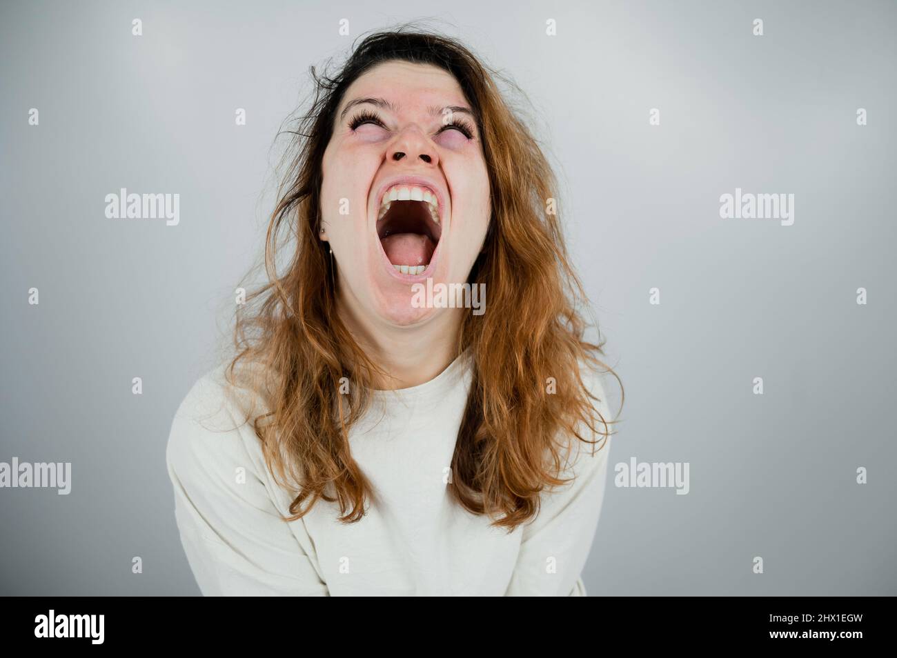 Close-up portrait of insane woman in straitjacket on white background Stock Photo - Alamy