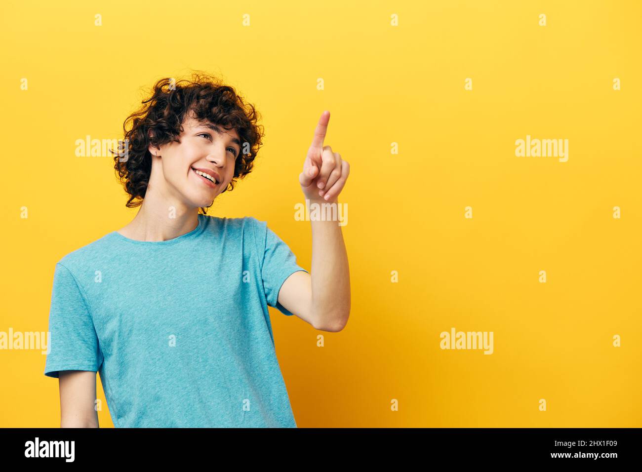 smiling guy showing thumb up yellow background Stock Photo - Alamy