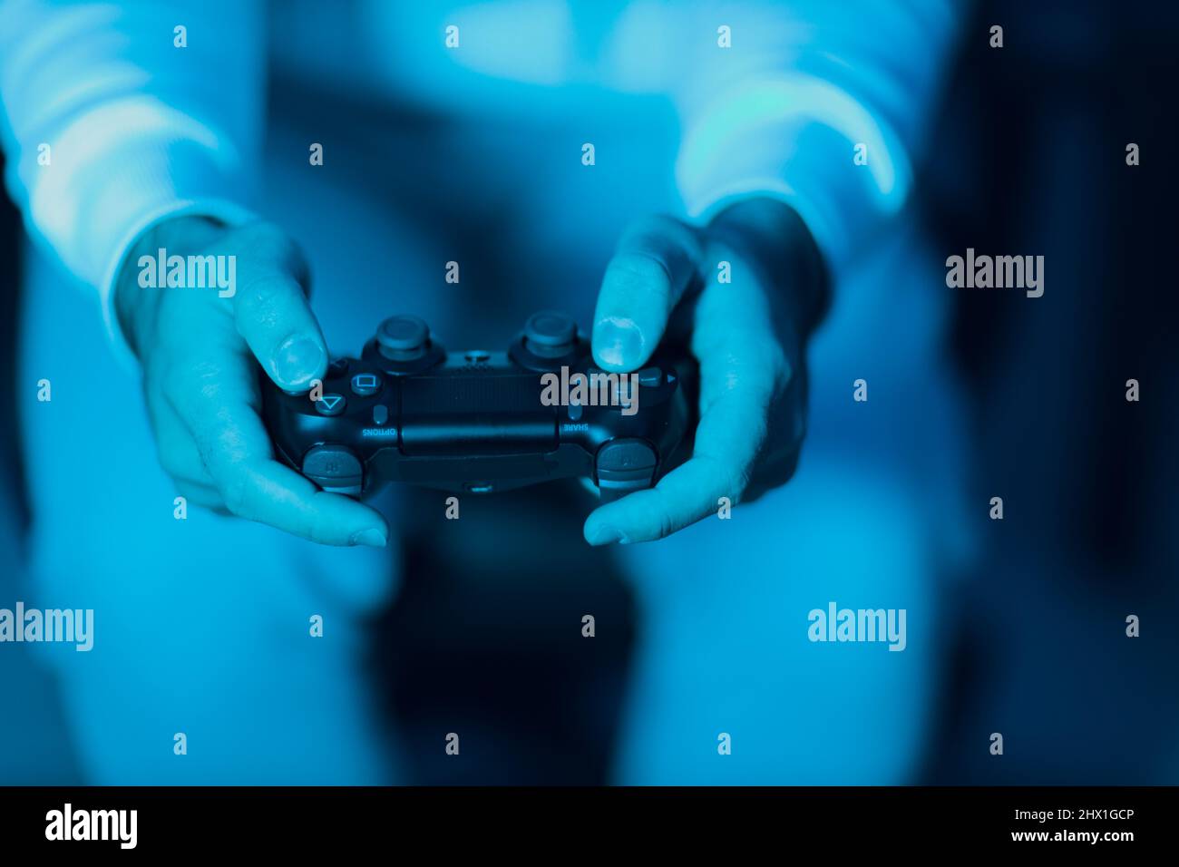 Guy young adult man gamer playing video game on game console hold ...