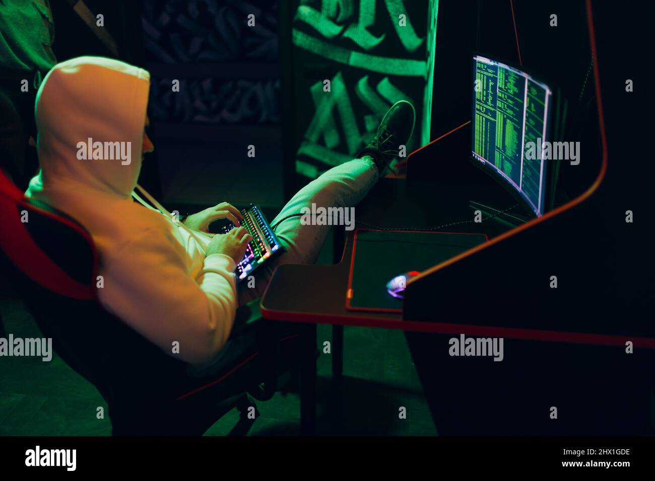 Hacker in hoodie working hacks code site on personal computer Stock ...