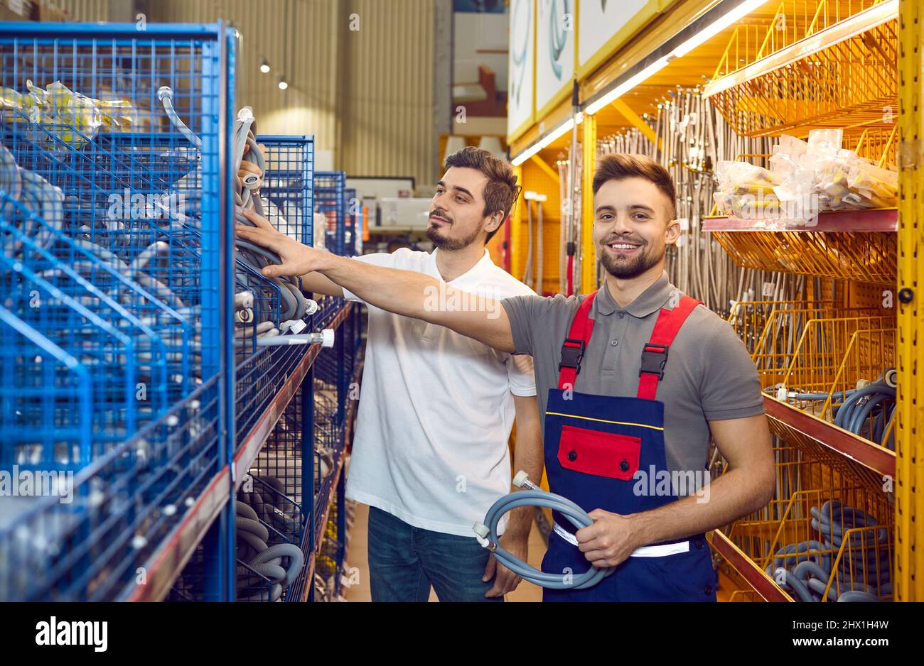 Salesperson at a DIY store helping his customer choose a new washing ...