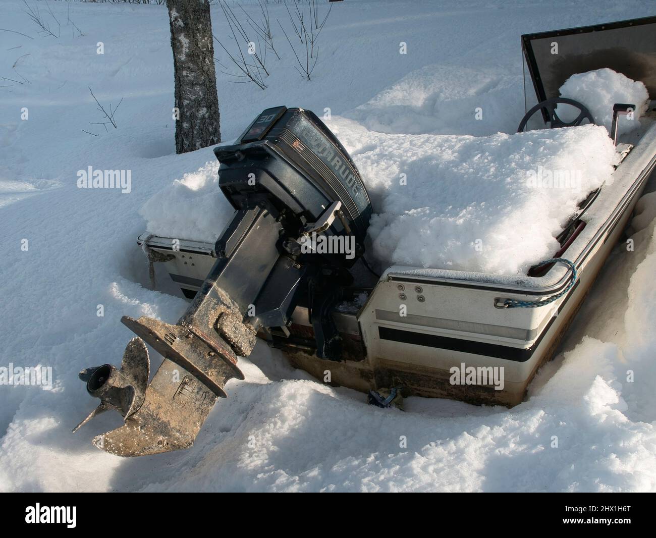 Old Evinrude outboard motor boat in the snow Stock Photo - Alamy