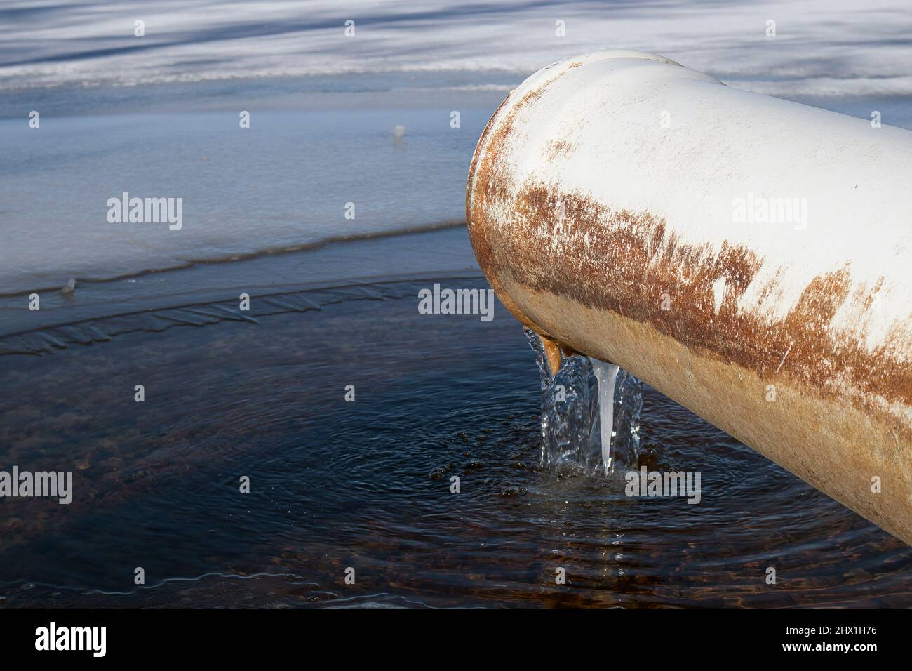water running out of drain pipe into frozen lake, Finland Stock Photo ...