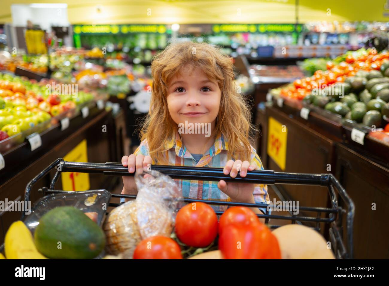 Sale, consumerism and child. Happy little kid with food in shopping ...