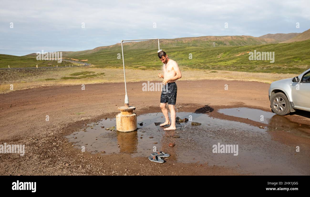 Man in swimsuit showering at the shower near Krafla, Iceland Stock ...