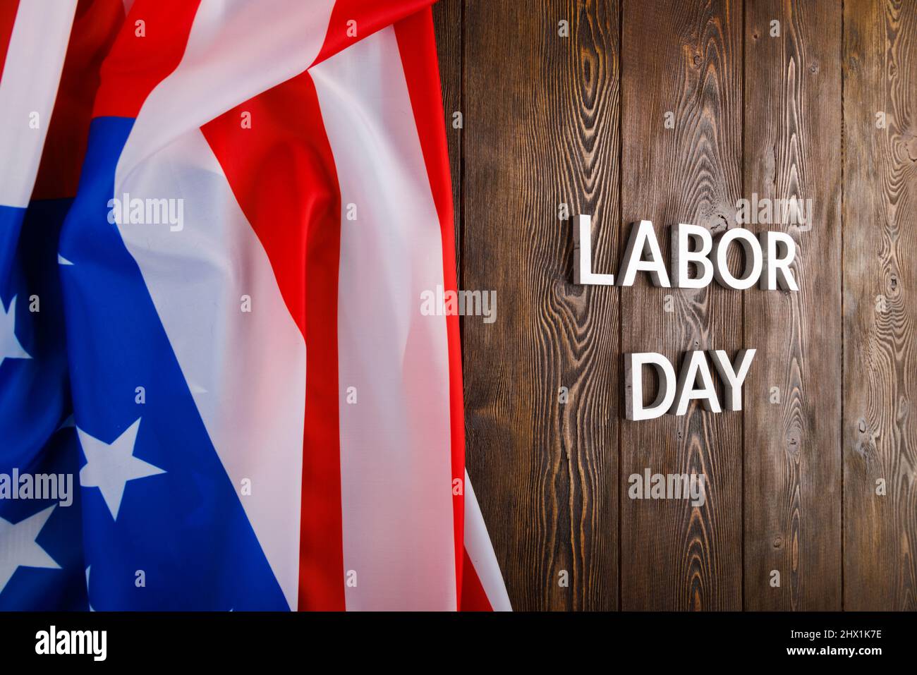 words labor day laid with silver metal letters on wooden surface with ...