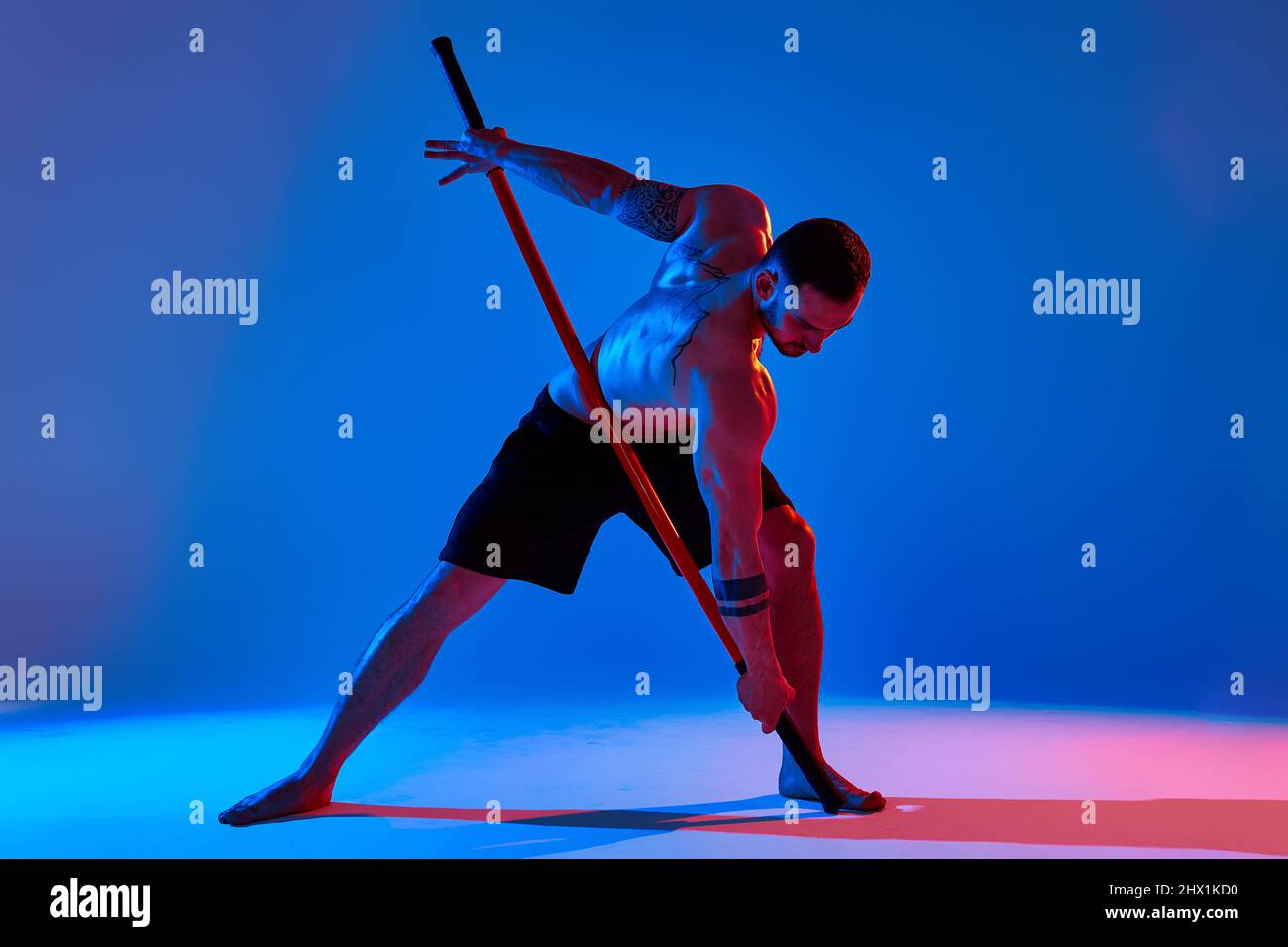 athlete men with stick training karate using sports tool in studio on ...