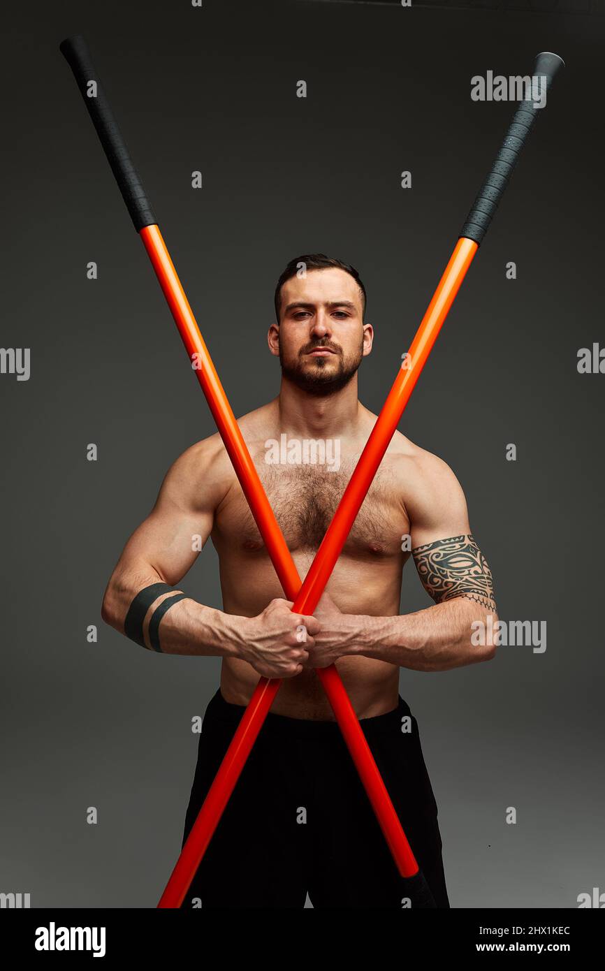 athlete men with stick training karate using sports tool in studio on ...