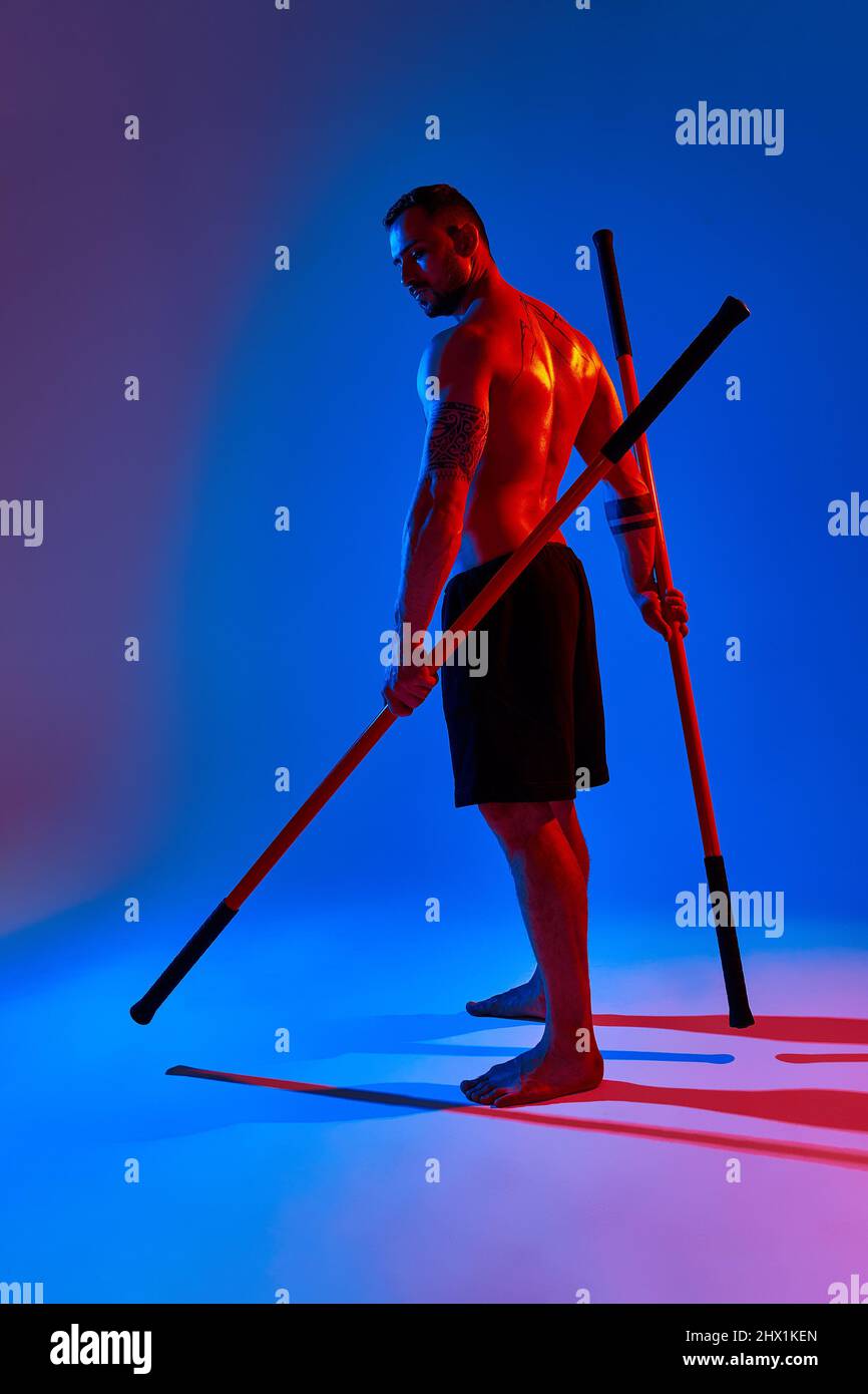 athlete men with stick training karate using sports tool in studio on ...