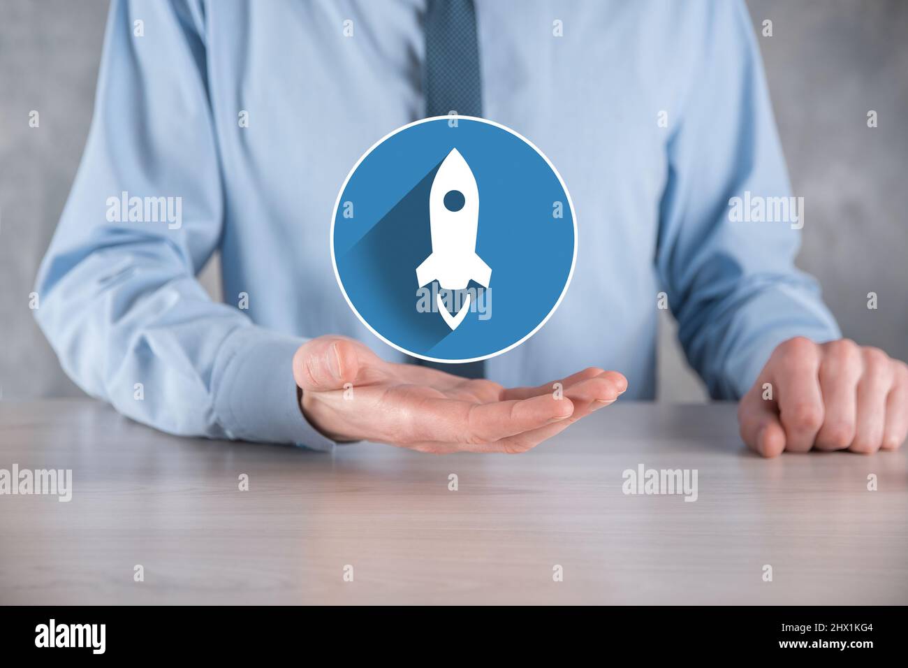 Startup business concept, Businessman holding in hand icon rocket is ...