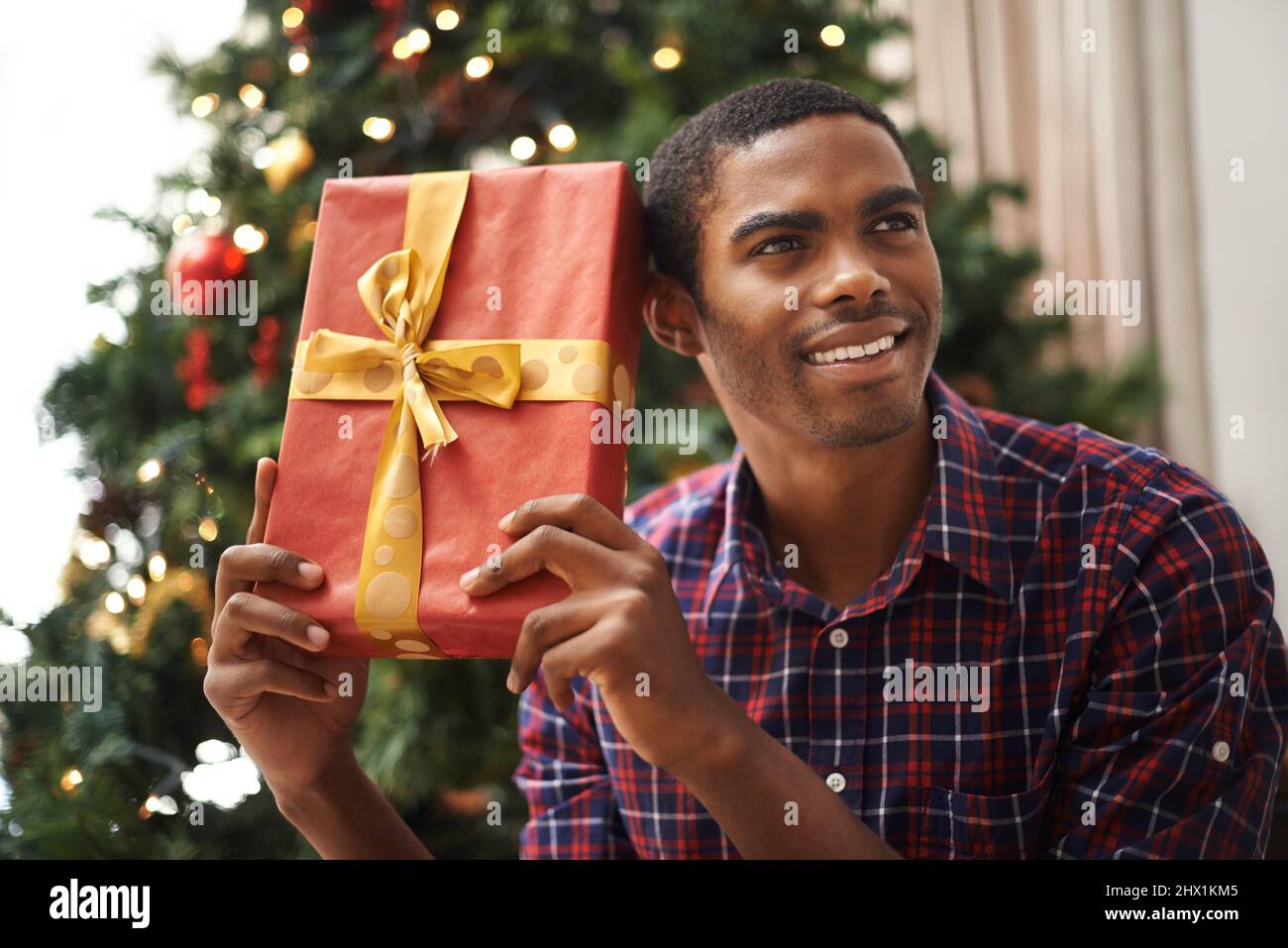 Christmas is my favourite time of year. Shot of a handsome young man ...