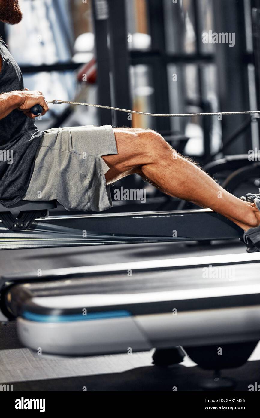 Training legs in the simulator, the athlete works with his legs on the ...