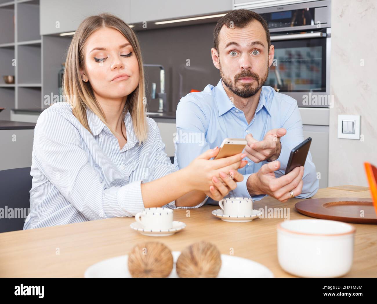 Discontented couple with phones Stock Photo - Alamy