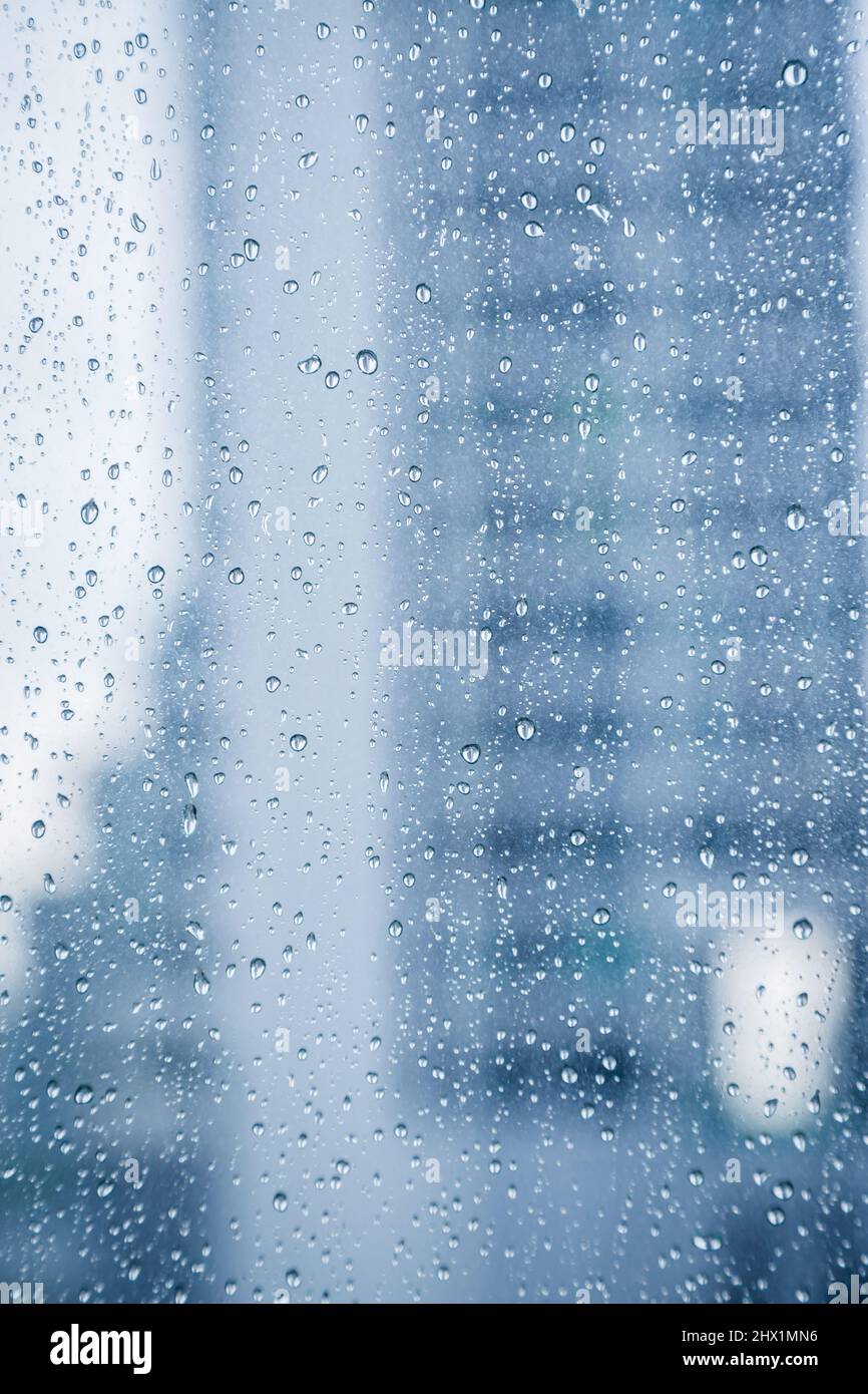 Abstract image of Rain drops on the dirty glass windows with modern ...