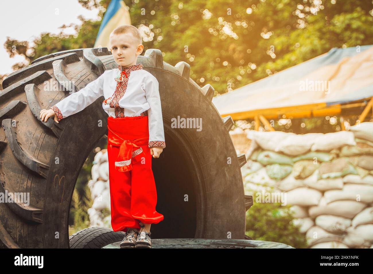 Ukrainian child boy in traditional national dress stands on roadblock ...
