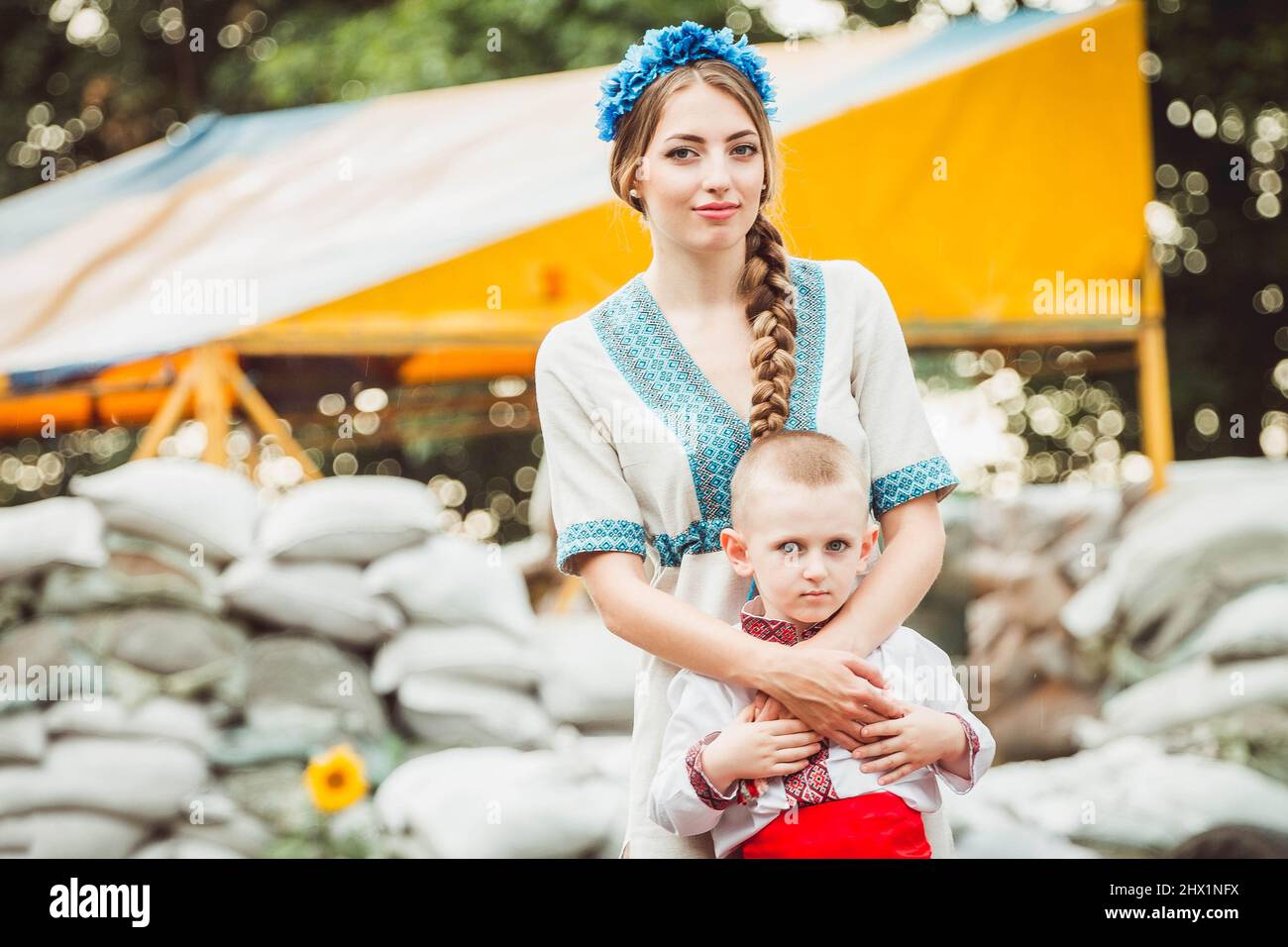 Young ukrainian woman stands with child boy in traditional national ...