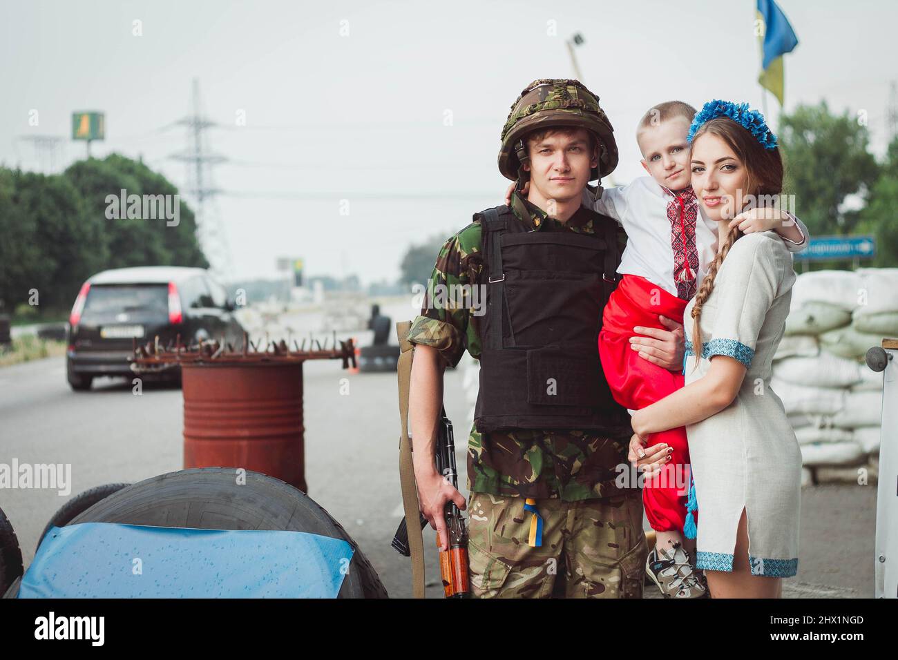 Young ukrainian woman and child boy in traditional national dress stand ...