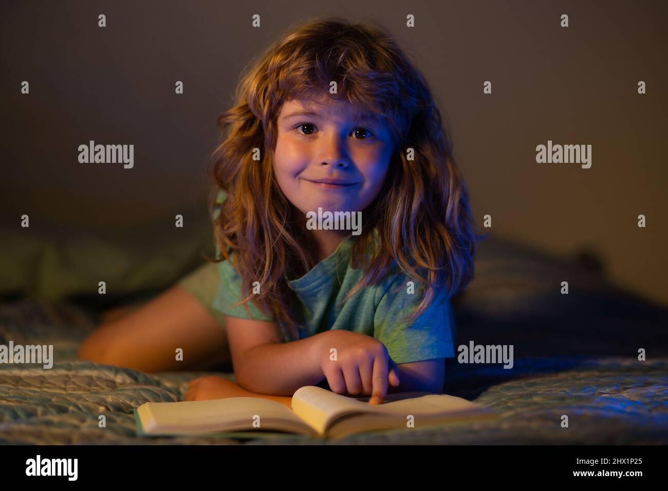 Kids bedtime. Boy reading a book in bed. Child reading story with book ...