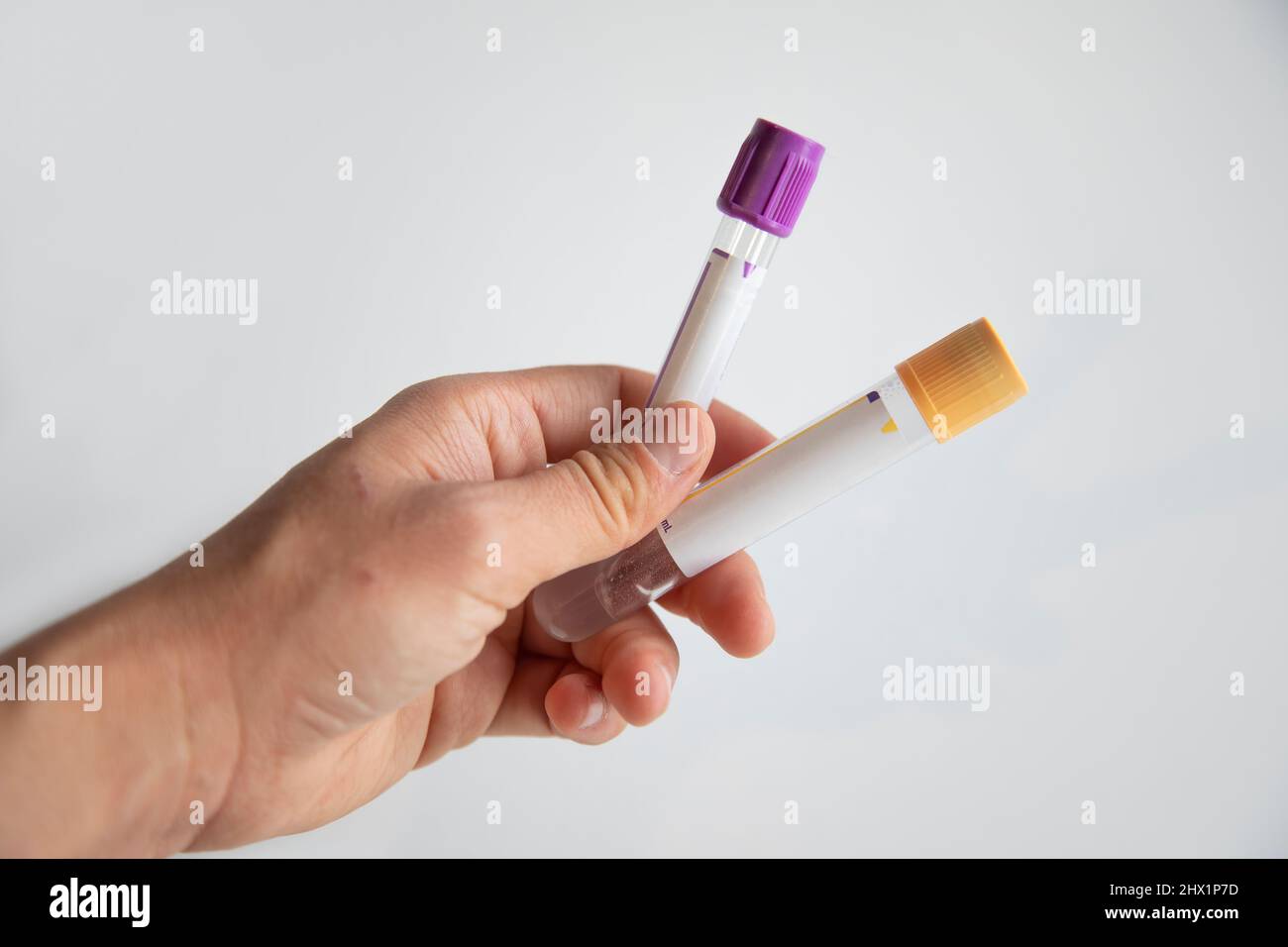 woman's hand holding tubes for blood collection Stock Photo - Alamy