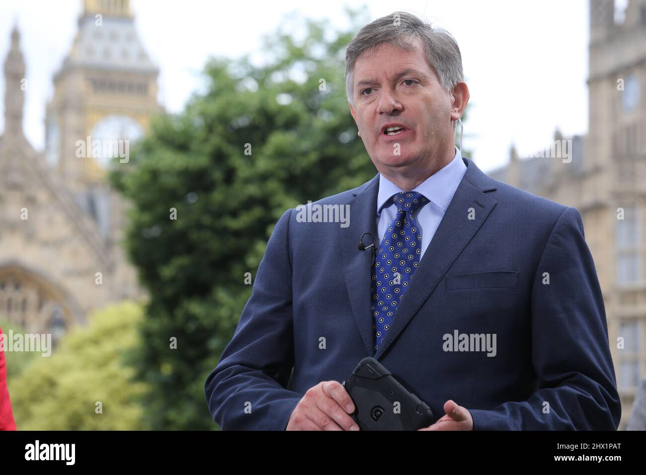 A photograph of BBC anchorman Simon McCoy speaking with Big Ben in the ...