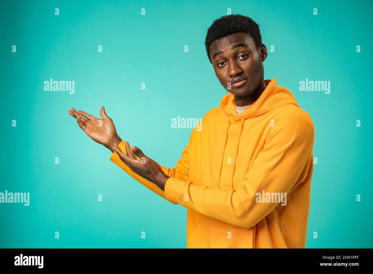 Happy African American man pointing finger at copy space Stock Photo ...