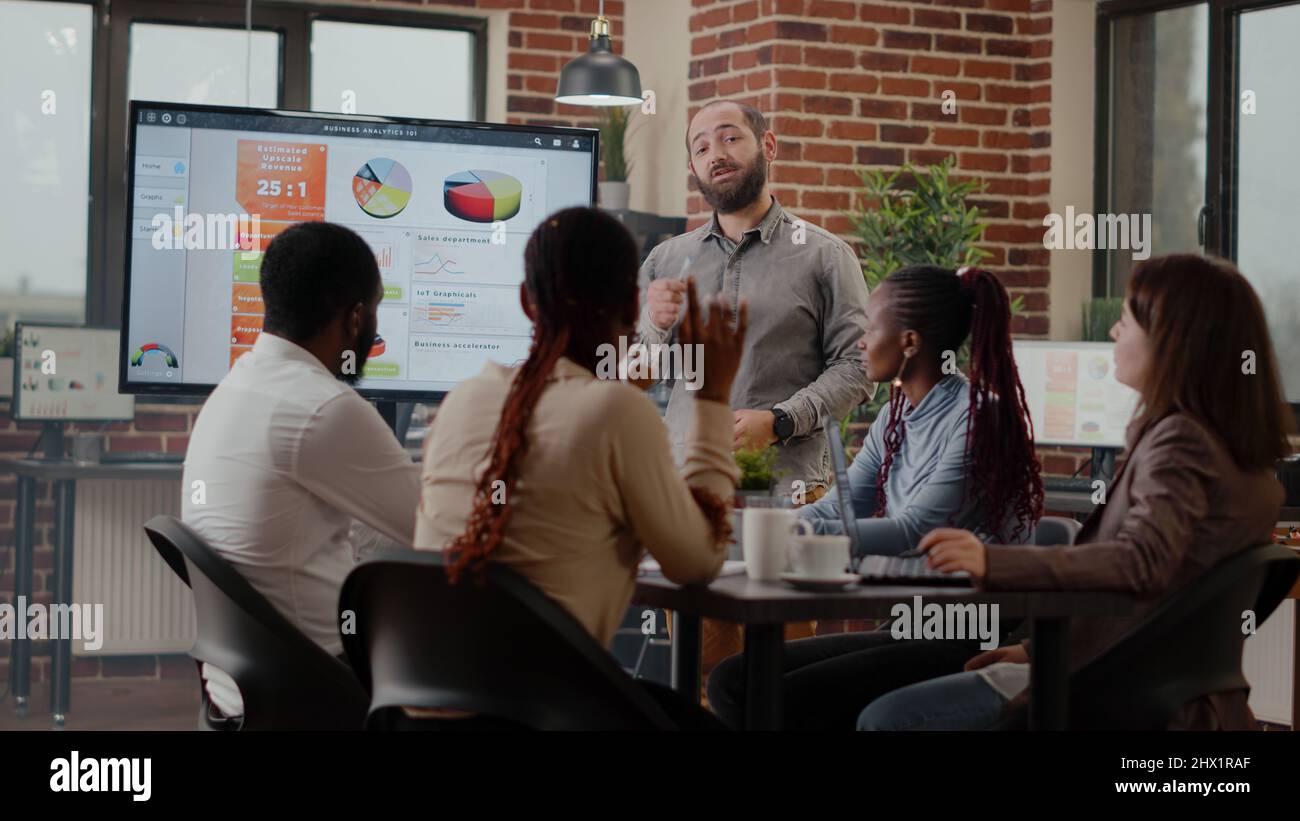 Employee explaining marketing strategy to people at business meeting in ...