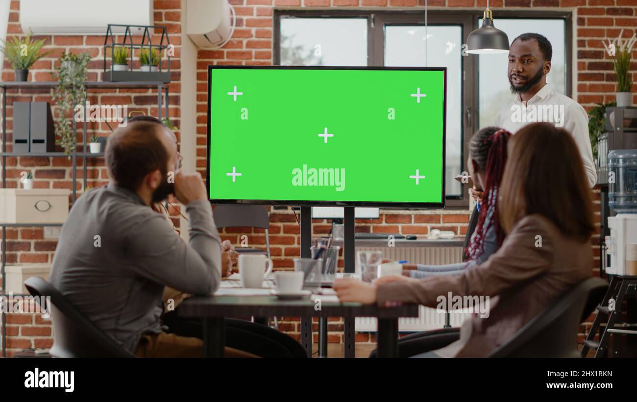 People talking and using isolated green screen on display in office ...