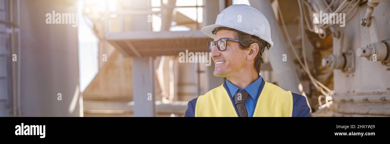 Cheerful male engineer standing at manufacturing plant Stock Photo - Alamy