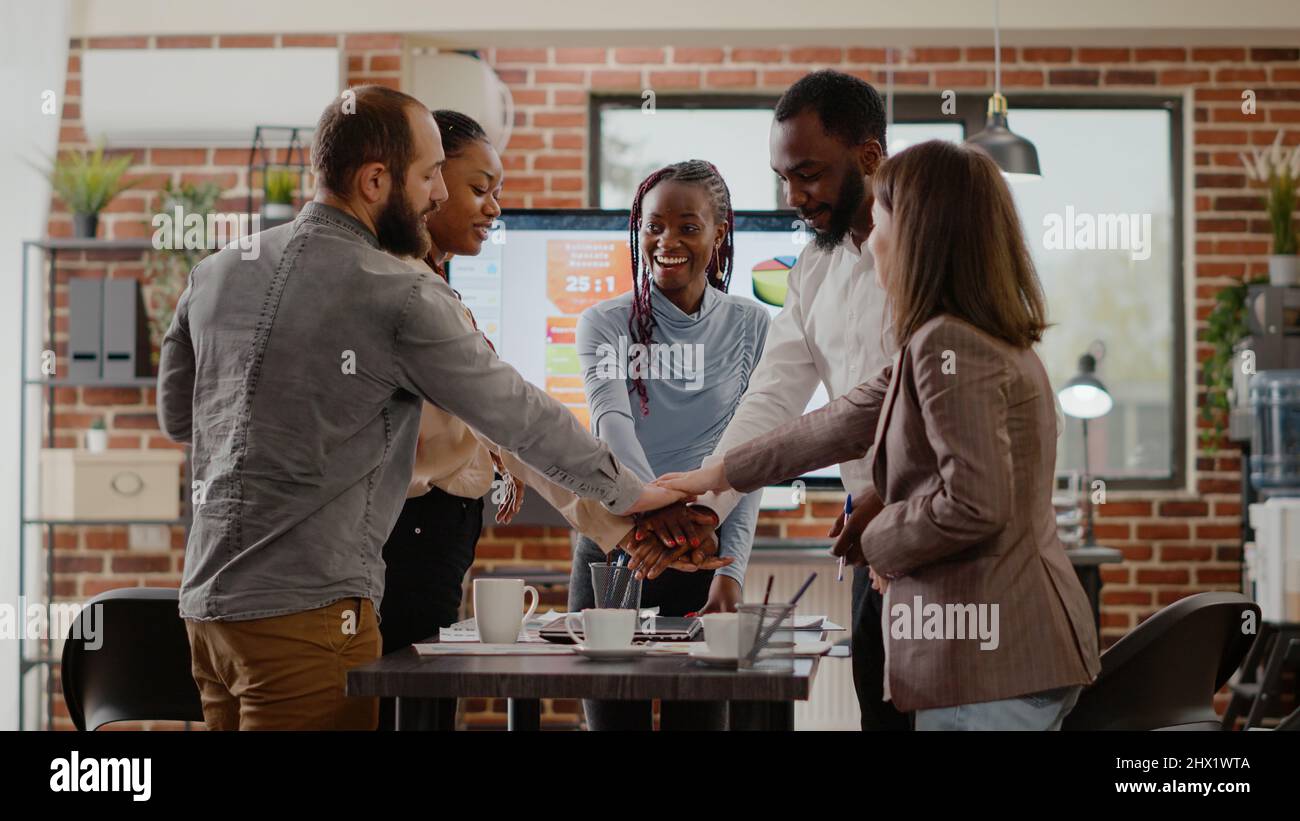 Satisfied colleagues celebrating teamwork achievement in business ...