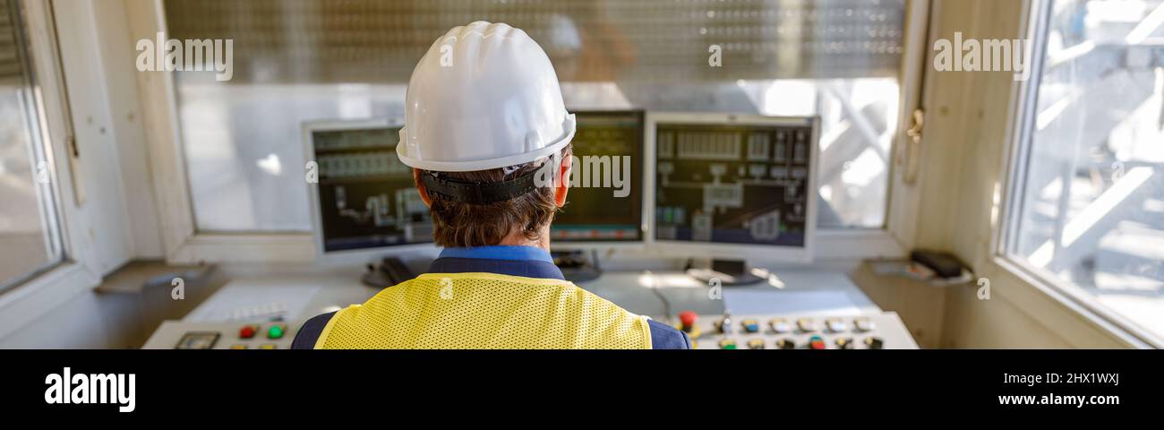 Male engineer using computers at manufacturing plant Stock Photo - Alamy