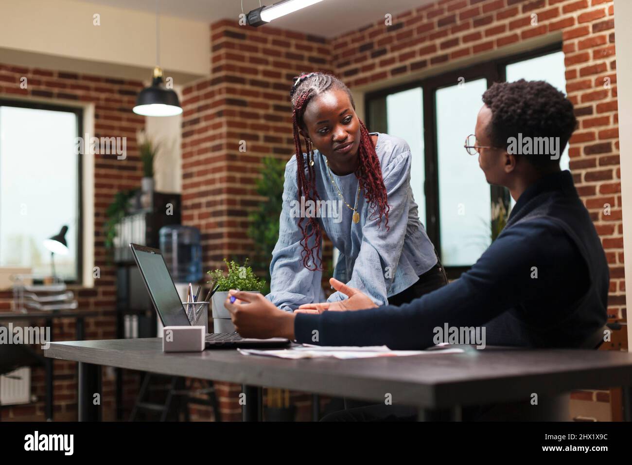 Research and development company office employees reviewing financial ...