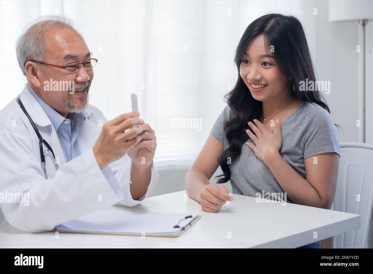 happy and glad Asian pregnancy check with doctor looking at pregnancy ...