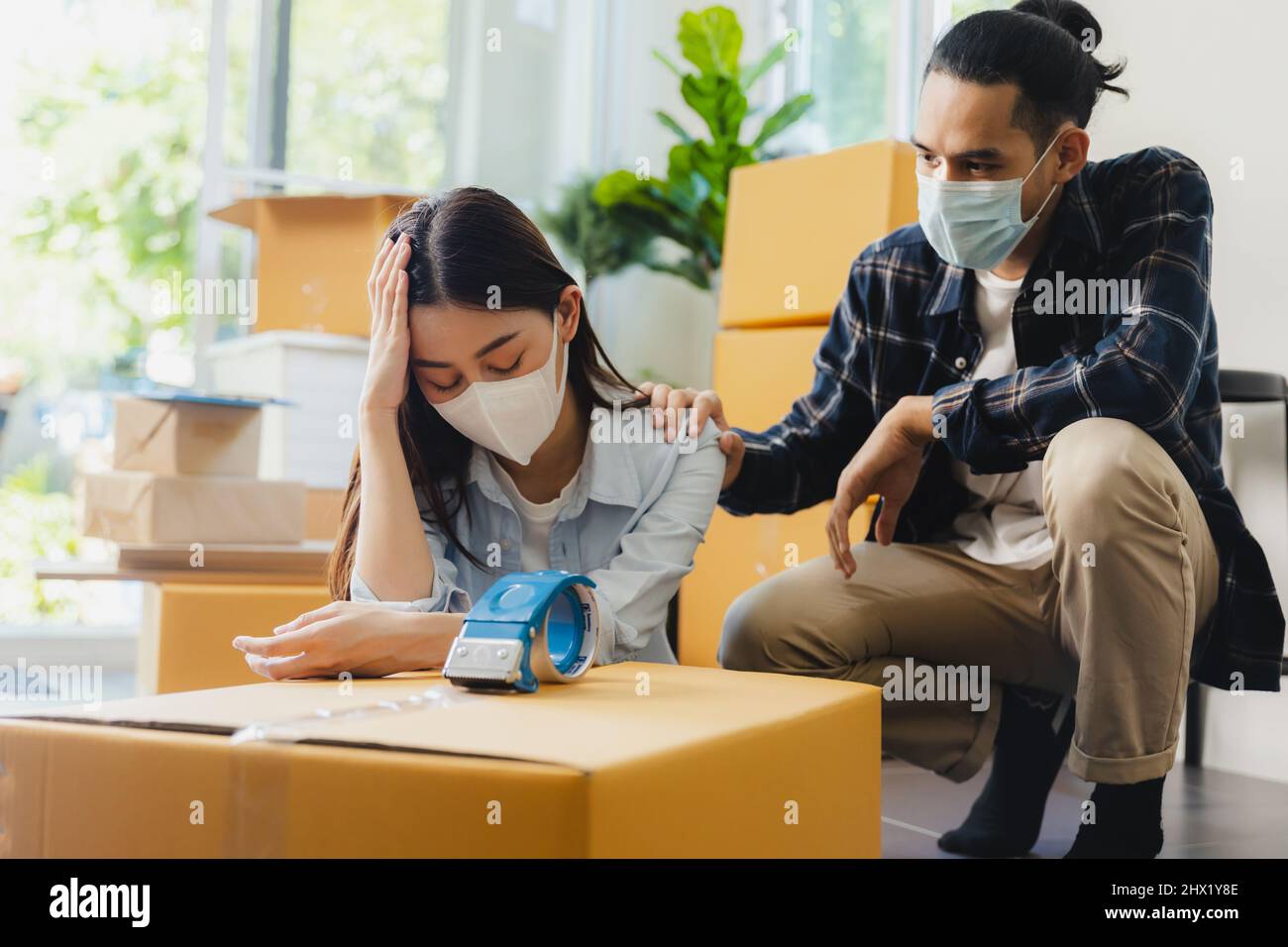 Sad Asian couple packed box and prepare to move house Stock Photo - Alamy