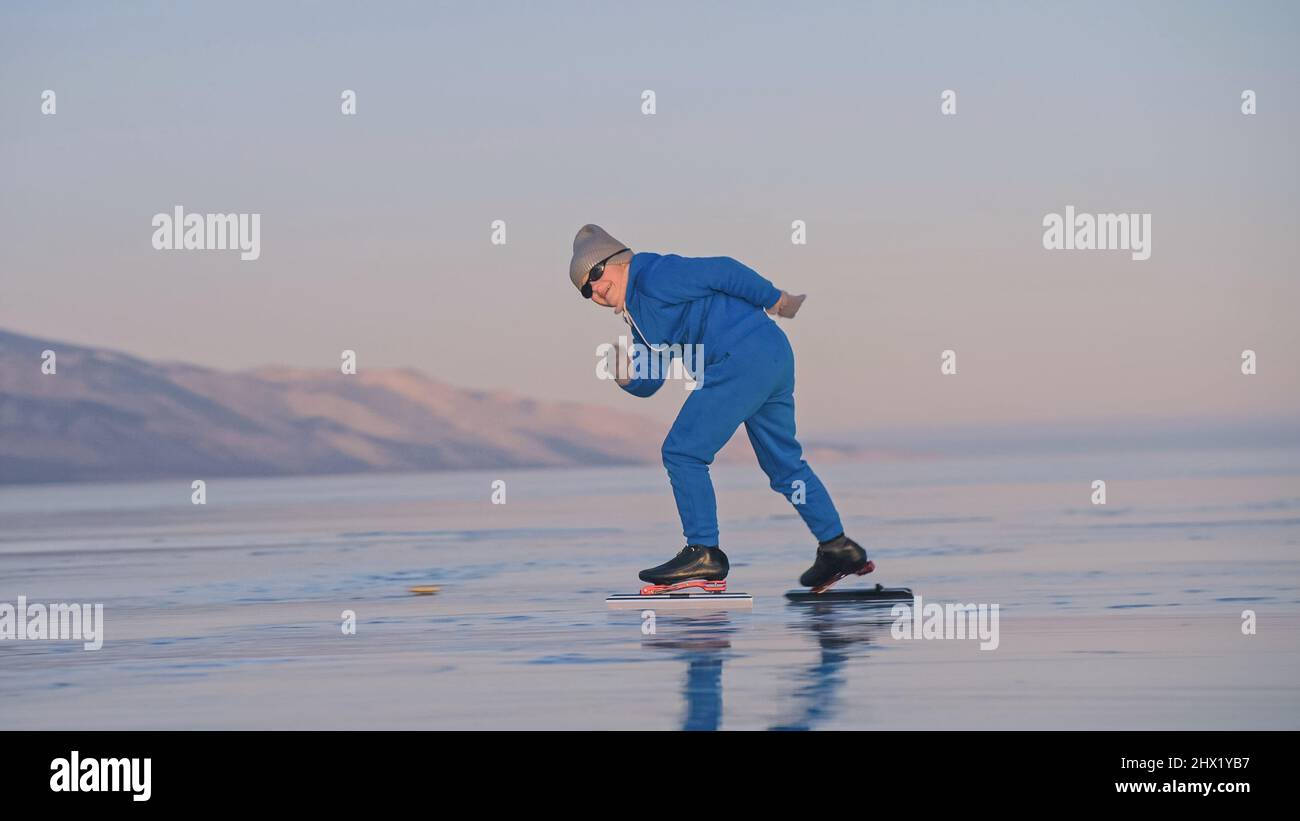 The child train on ice professional speed skating. The girl skates in ...