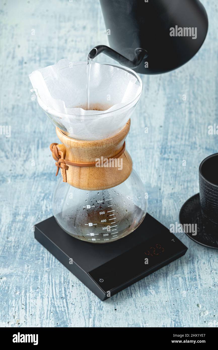 Professional barista brews coffee with pour over method. Alternative ...