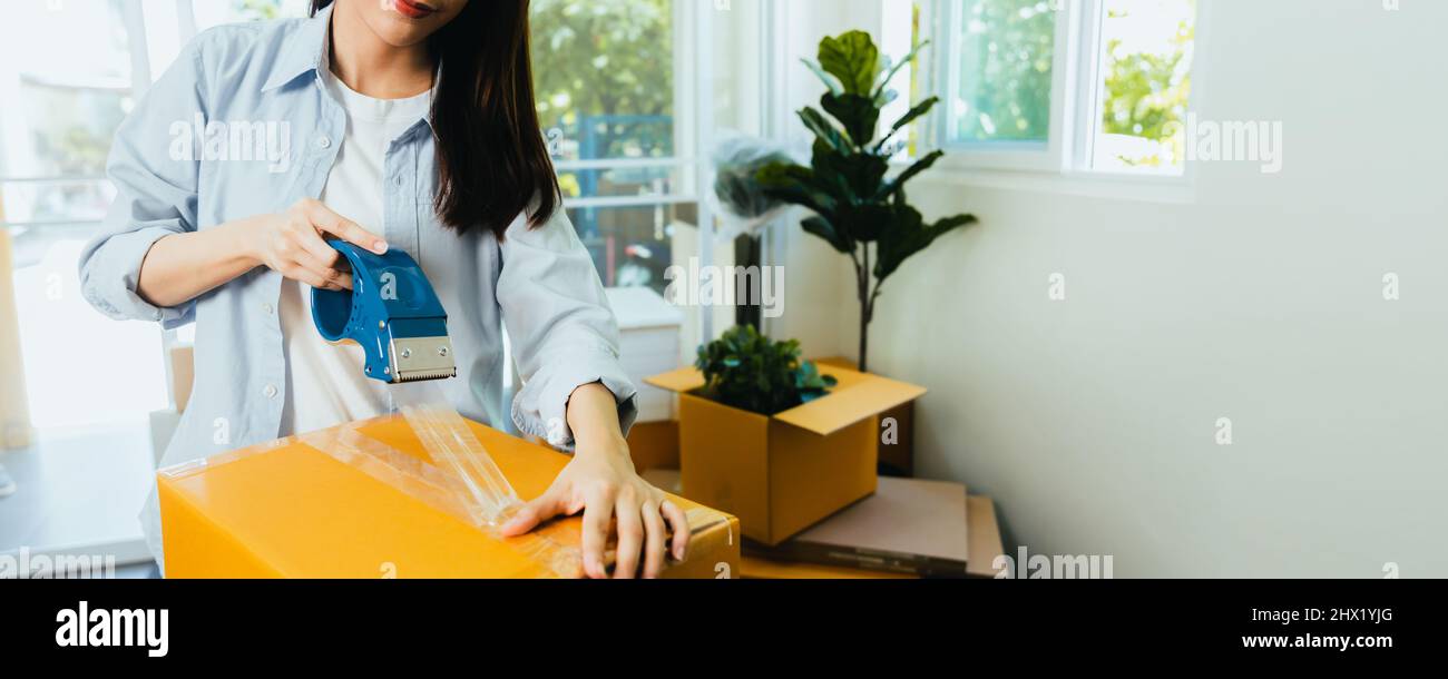 Woman packing cardboard box hi-res stock photography and images - Alamy
