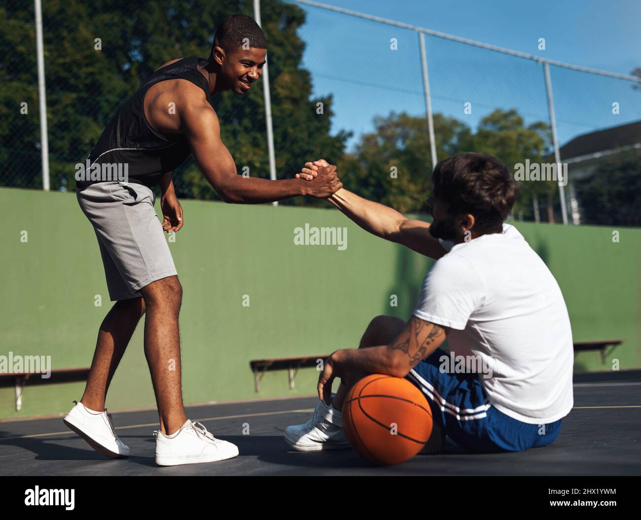 You played so well dude. Shot of two sporty young men shaking hands on ...