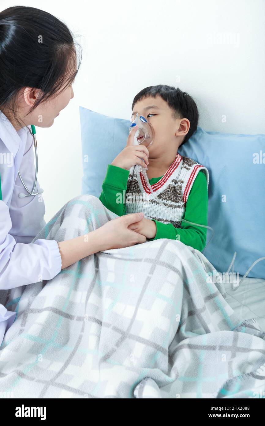 Happy child having respiratory illness helped by health professional ...