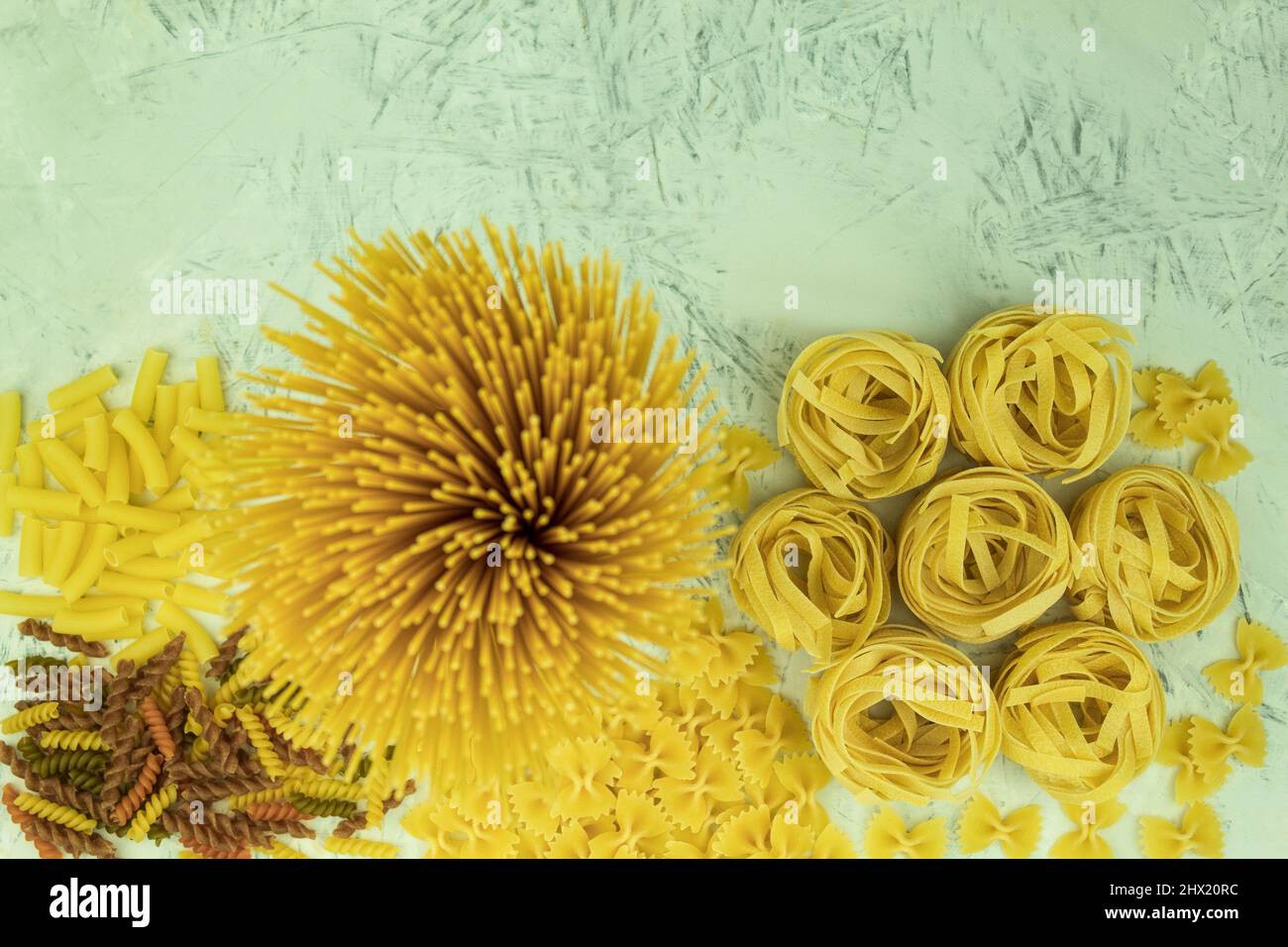 Assorted different types of pasta on the table. Various types of raw ...