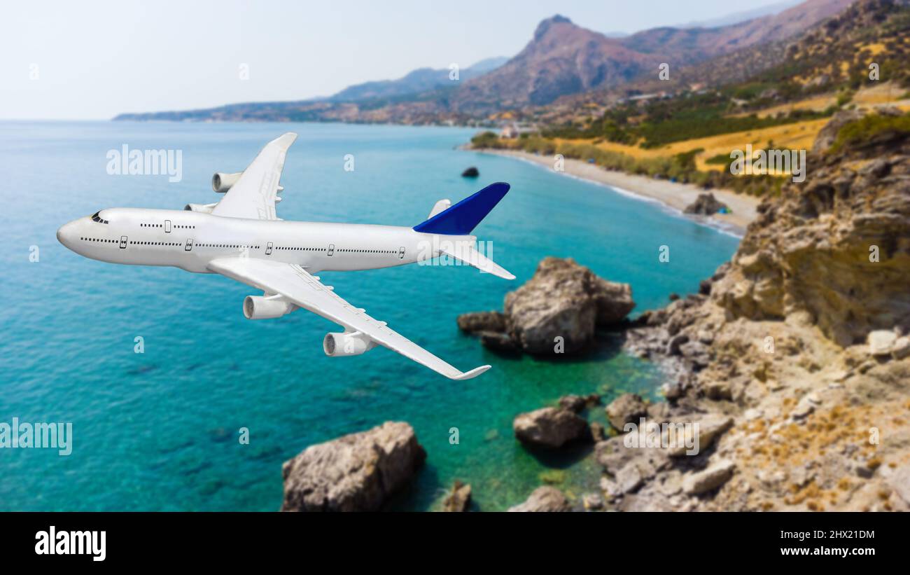 Airplane landing above beautiful beach and sea background Stock Photo ...