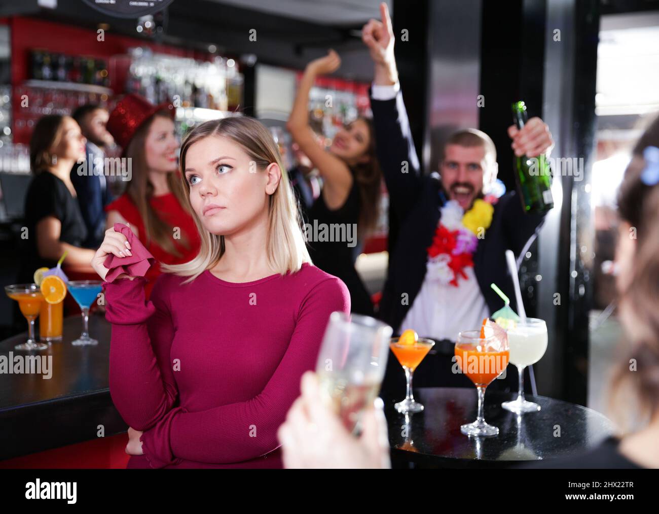Offended woman with drunk man on party at nightclub Stock Photo - Alamy