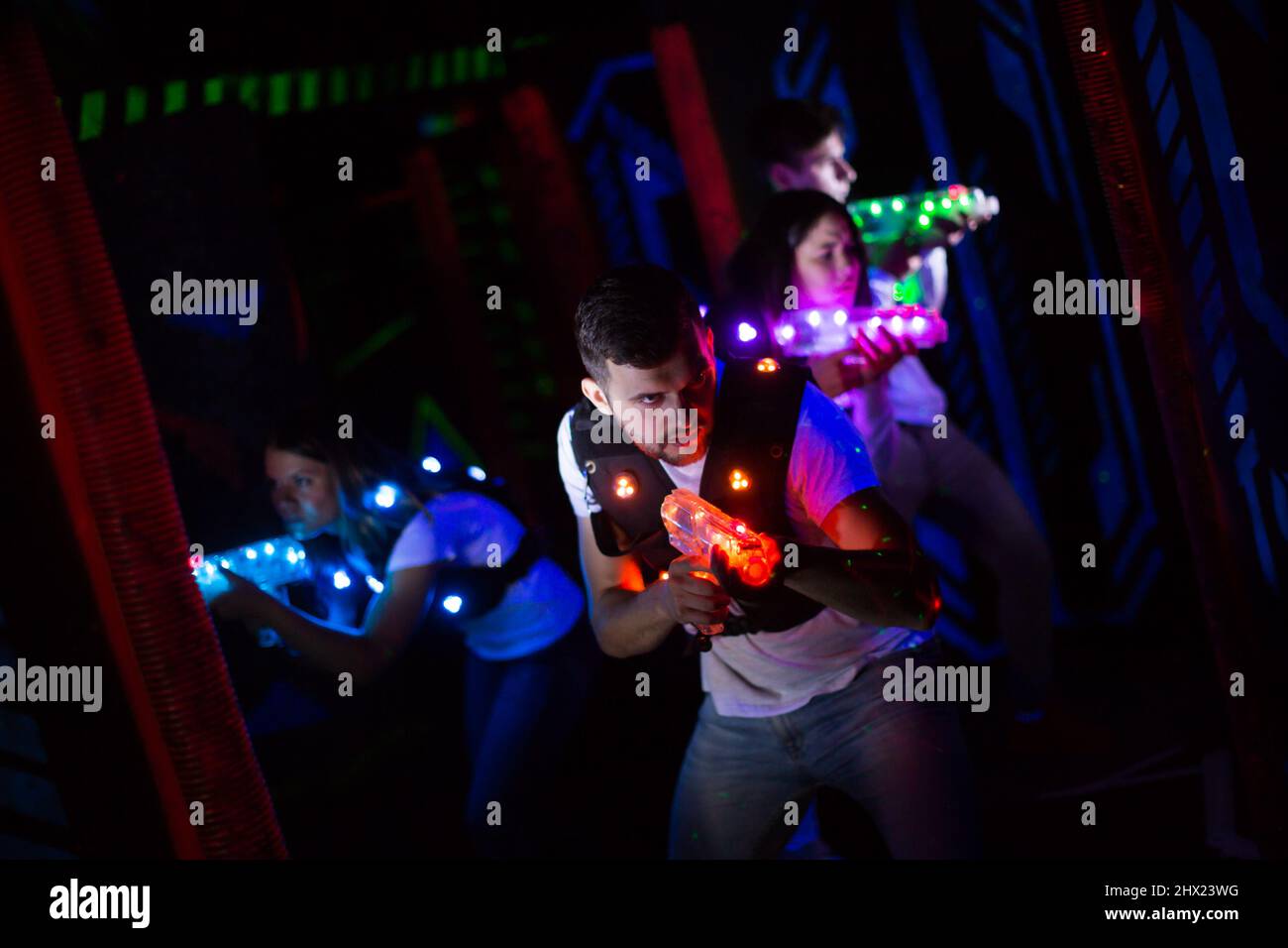Emotional guy playing laser tag Stock Photo - Alamy