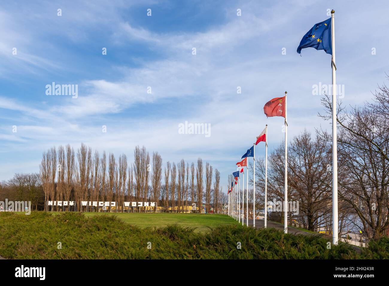 Masts with flags of Poland and European Union. Inscription: Nigdy ...