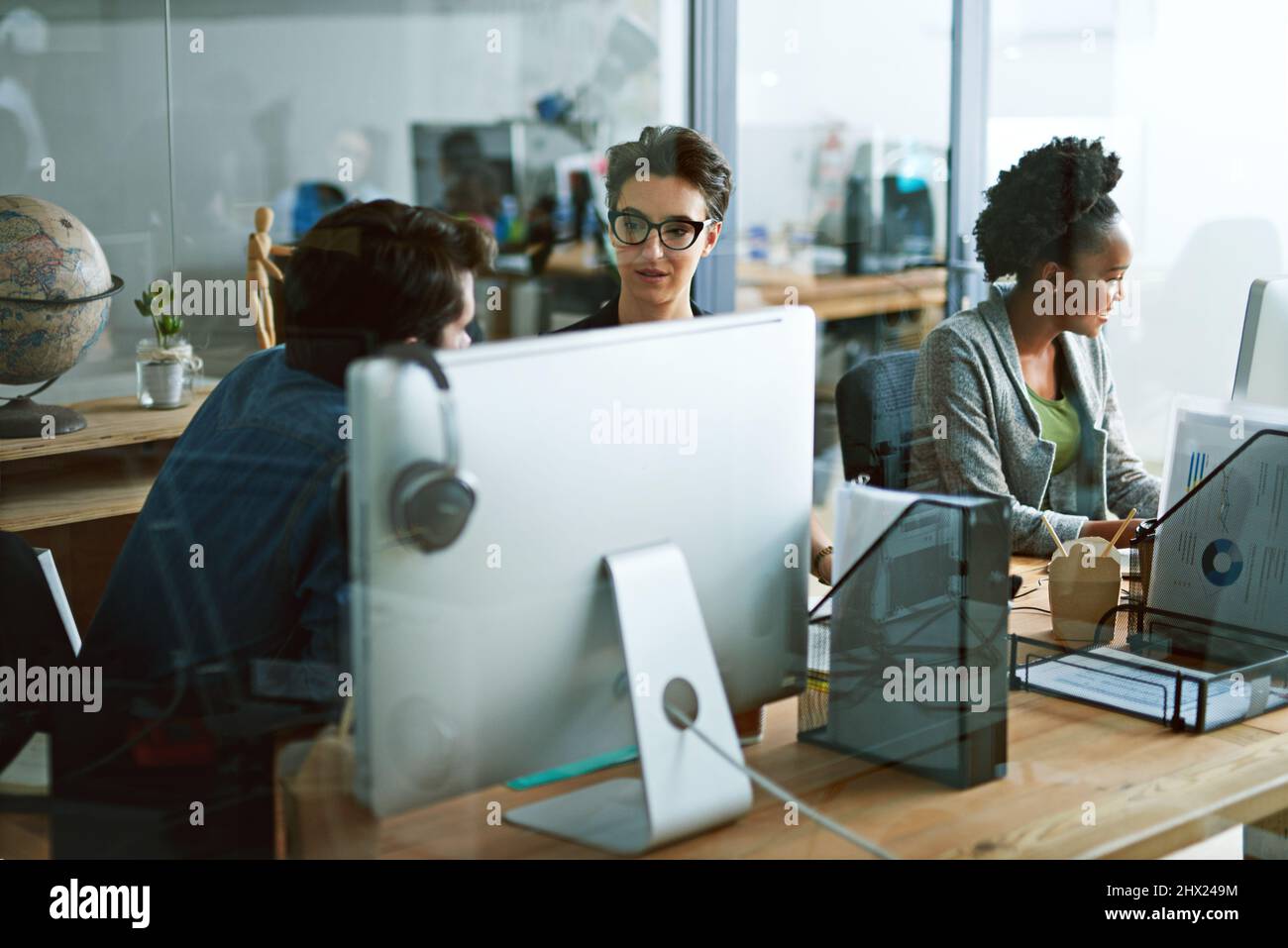 Discussing work. Shot of two businesspeople talking in the office ...