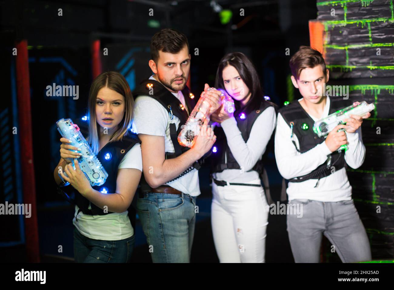 Young people in laser tag labyrinth Stock Photo - Alamy