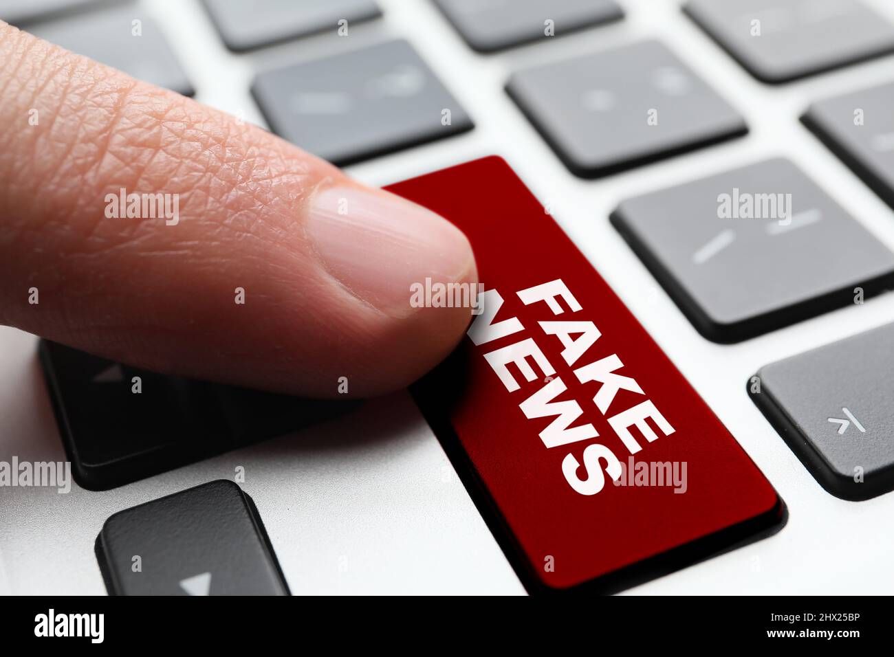 Man pressing key with text FAKE NEWS, closeup Stock Photo - Alamy