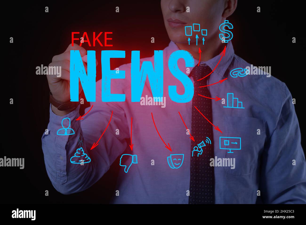 Young man writing text FAKE NEWS on transparent board Stock Photo - Alamy