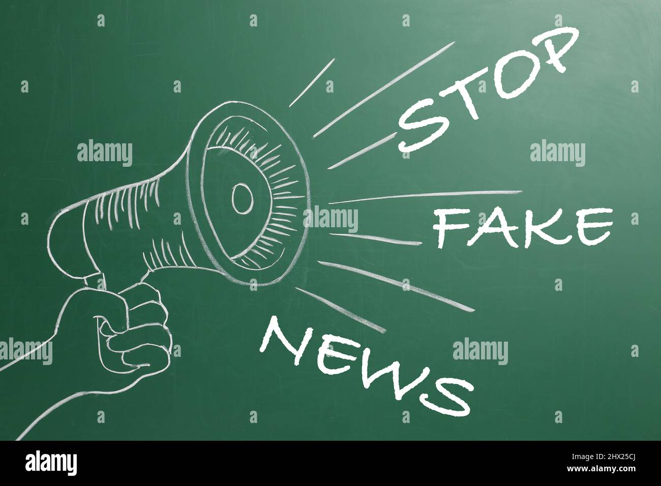 Drawing of hand with megaphone and text STOP FAKE NEWS on chalkboard ...