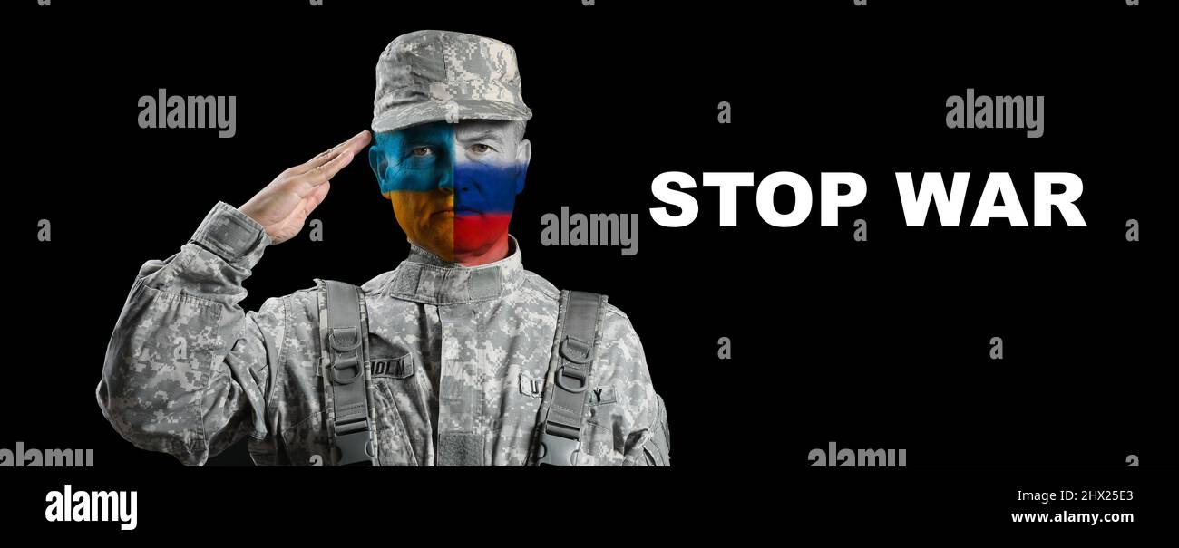 Saluting male soldier with face painted of colors of Russian and ...